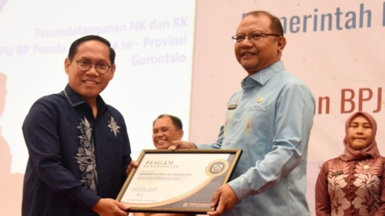 Deputi Direksi BPJS Kesehatan Wilayah X Octavianus Ramba (kiri) menyerahkan penghargaan kepada ...